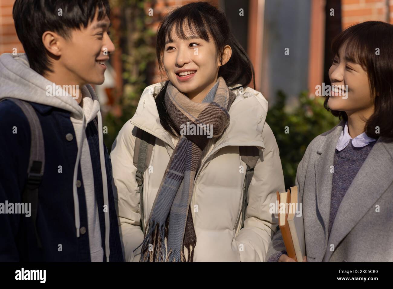 Happy Chinese college students talking on campus Stock Photo - Alamy