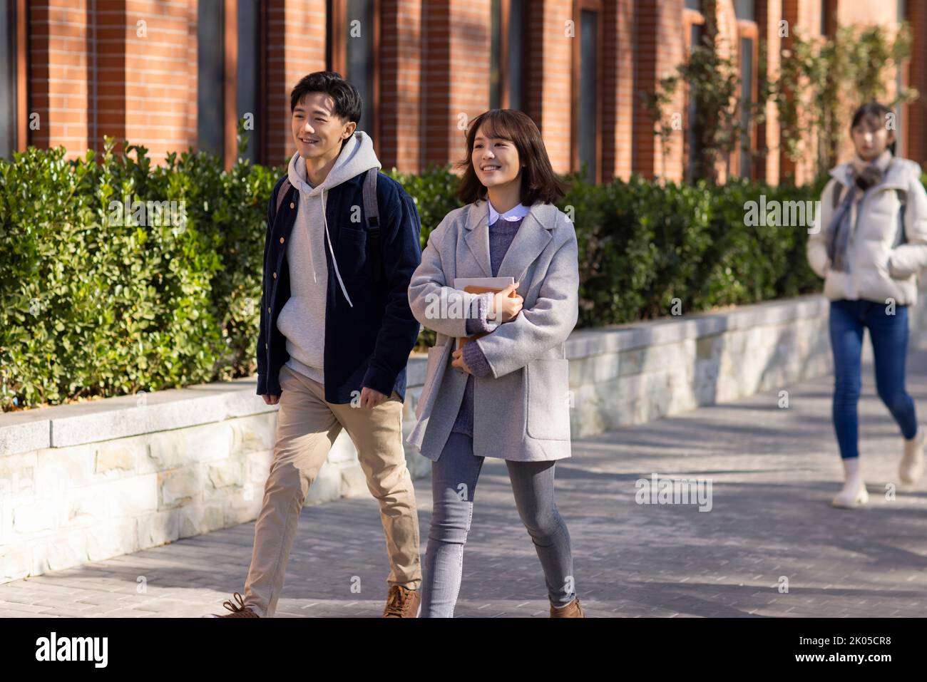 Happy Chinese college students walking on campus Stock Photo - Alamy