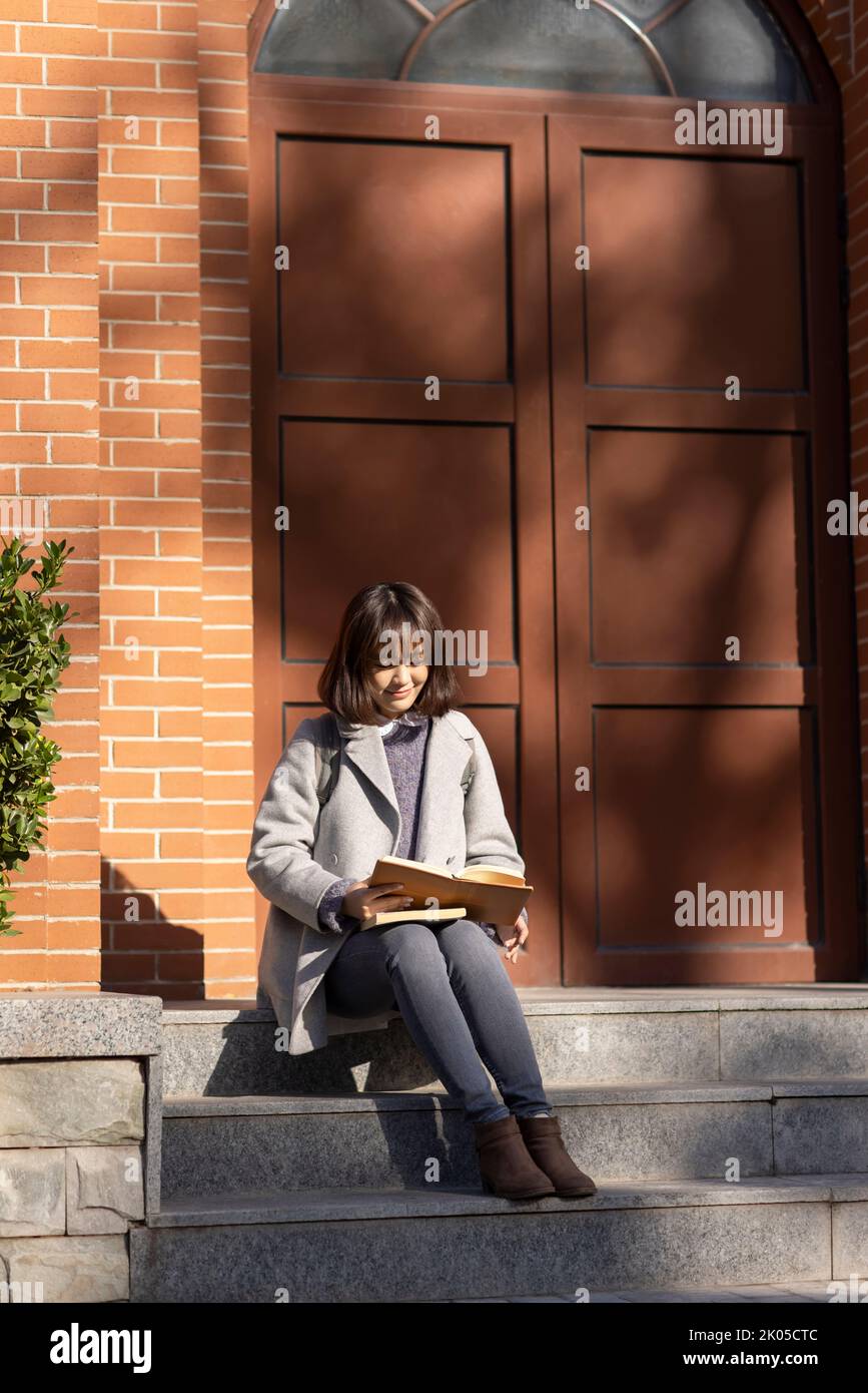 Happy Chinese college student reading on campus Stock Photo - Alamy