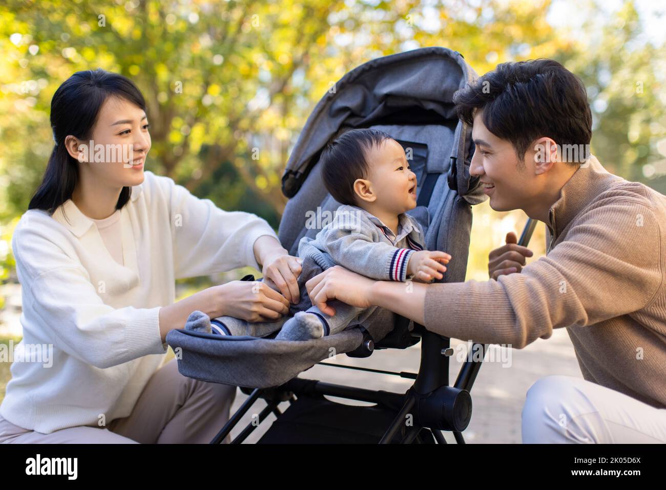 Young Chinese parents playing with baby in park Stock Photo - Alamy