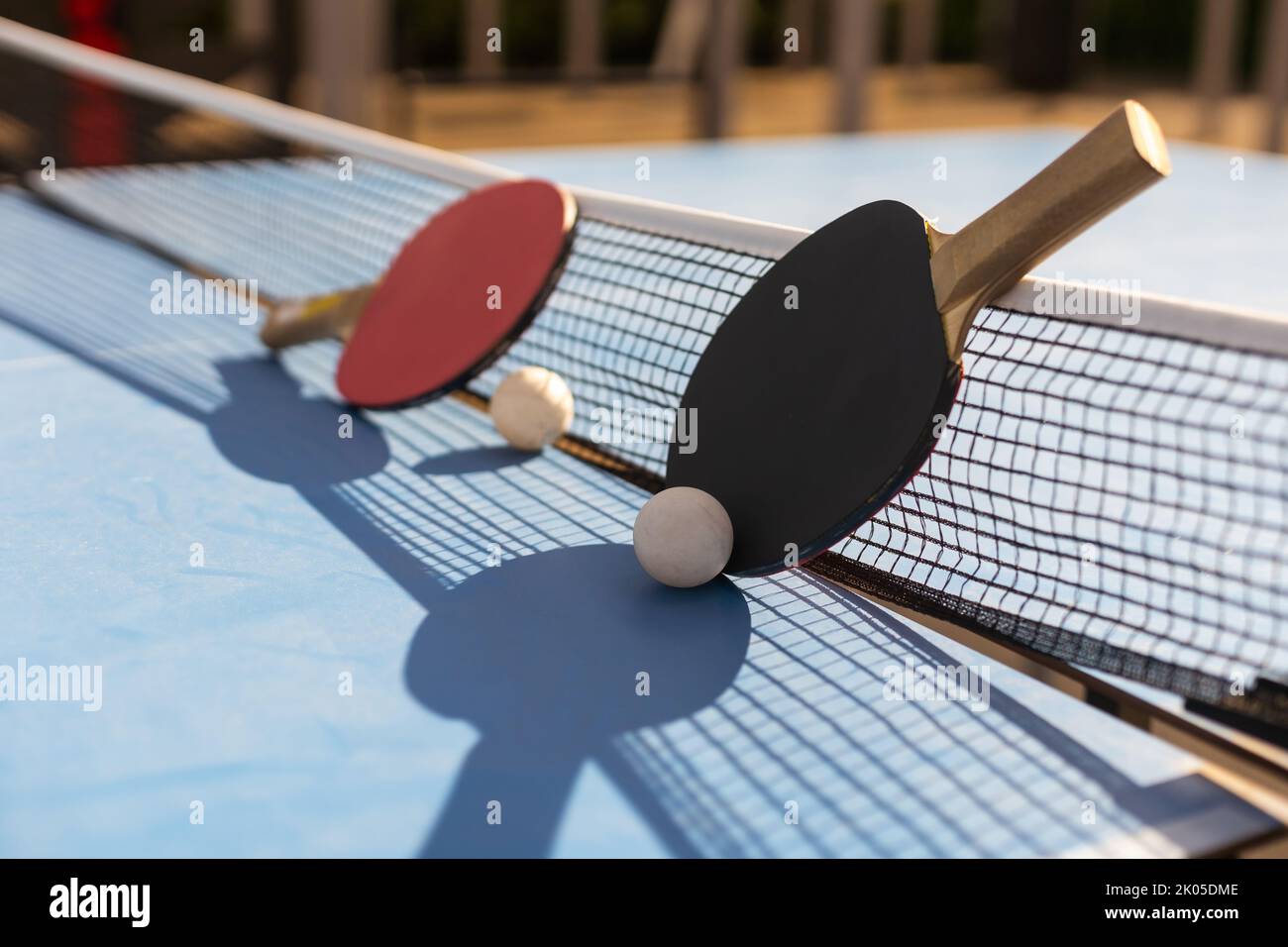 Ping pong table, rackets and balls in a sport hall Stock Photo - Alamy