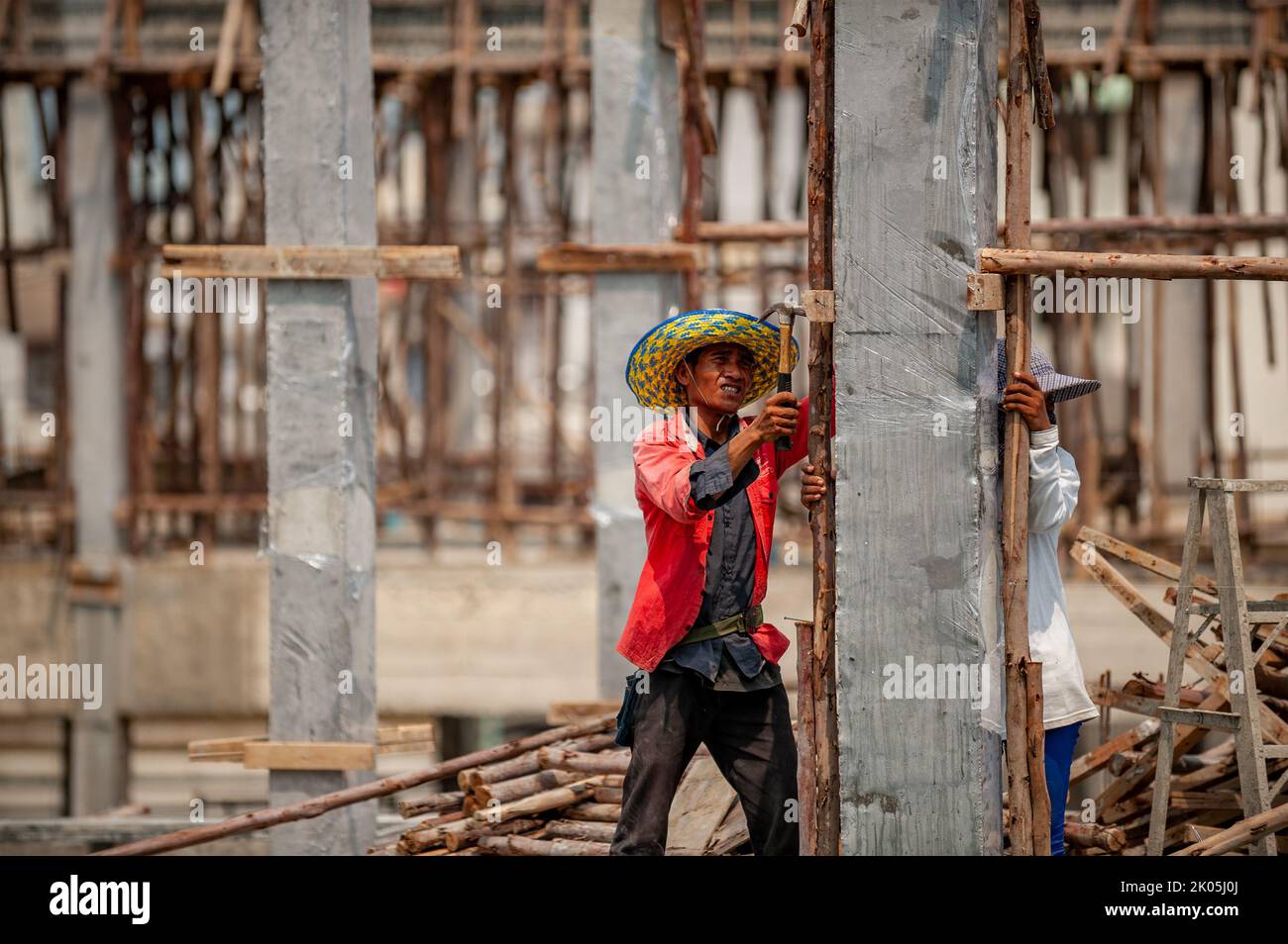 Bangkok, Thailand September 5, 2015: Construction worker nails ...