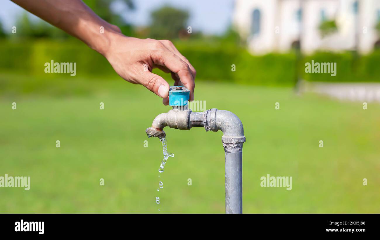 Old faucet outside the house dripping Stock Photo - Alamy