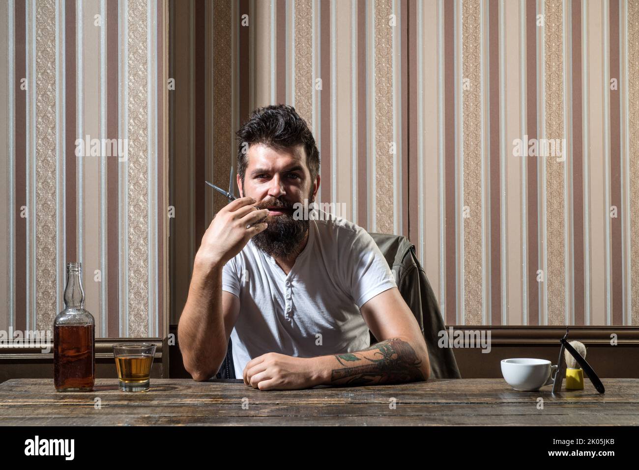 Brutal guy in modern Barber Shop. Barber shop. Portrait of stylish man ...