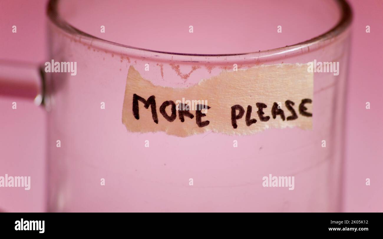 empty drinking glass of coffee with text word more please written on ...