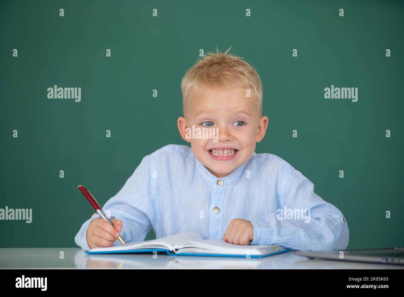 Funny face of little student of primary school study in classroom at ...