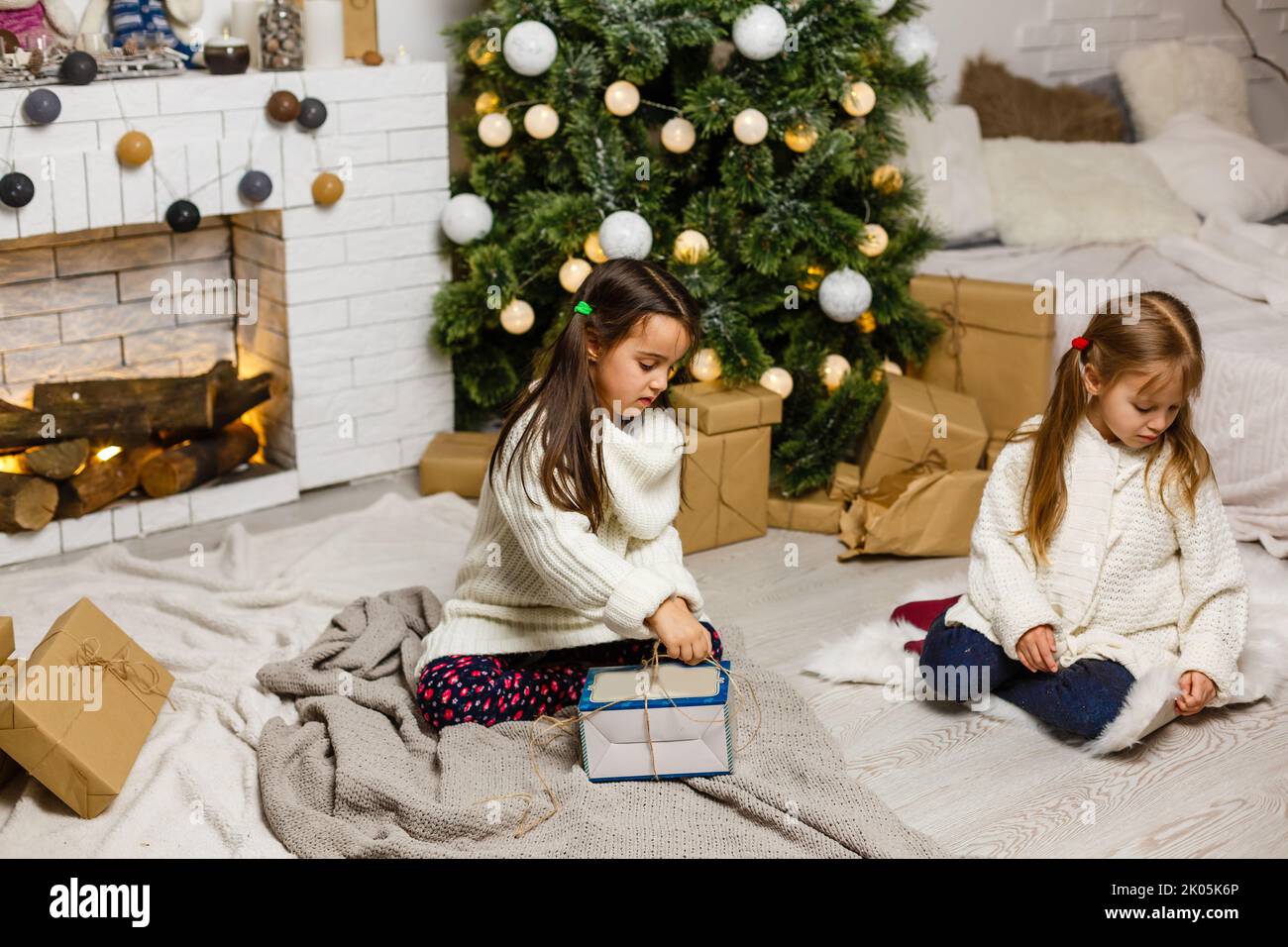 Two little girls in Christmas background Stock Photo - Alamy