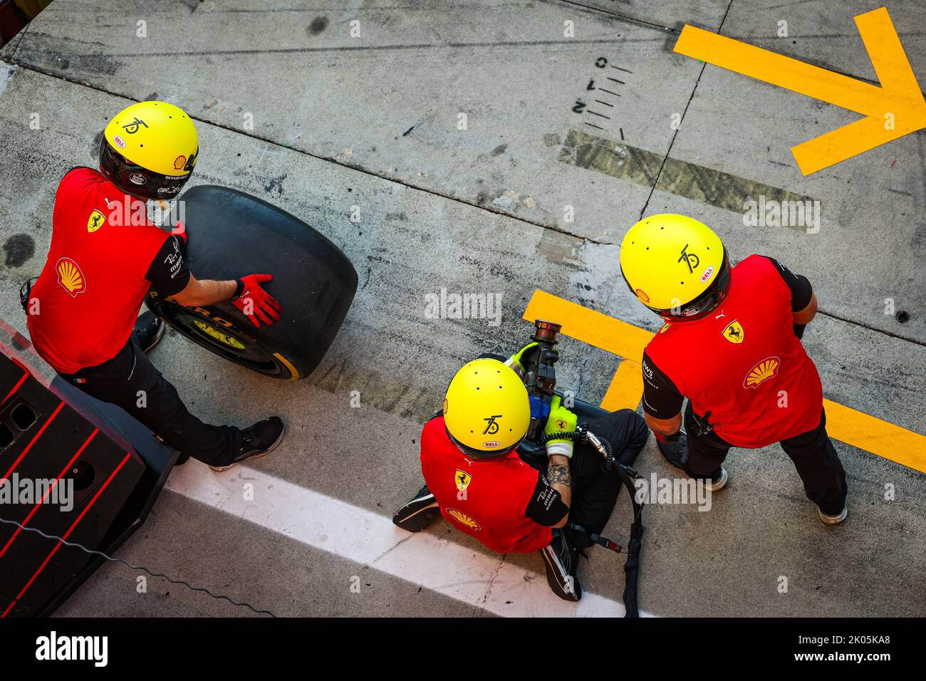 Scuderia Ferrari mechanics wearing the special livery clothes and ...