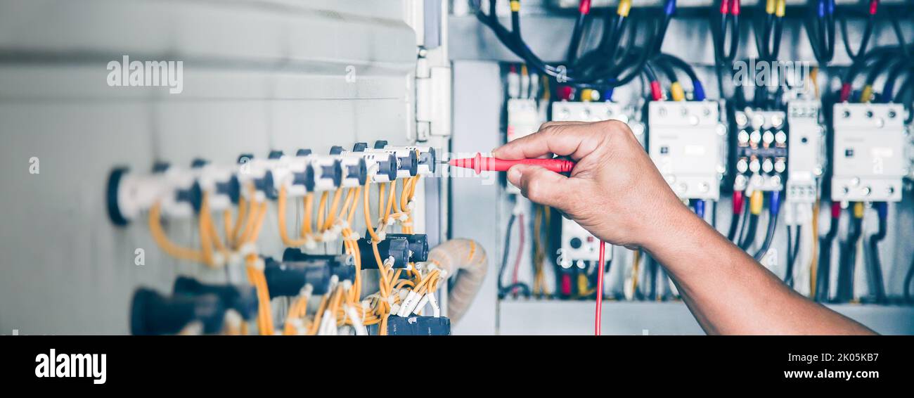 An electrical engineer is inspecting the operation of an electrical ...