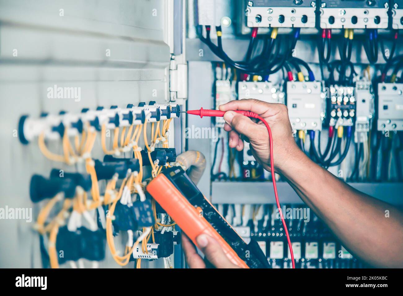 An electrical engineer is inspecting the operation of an electrical ...