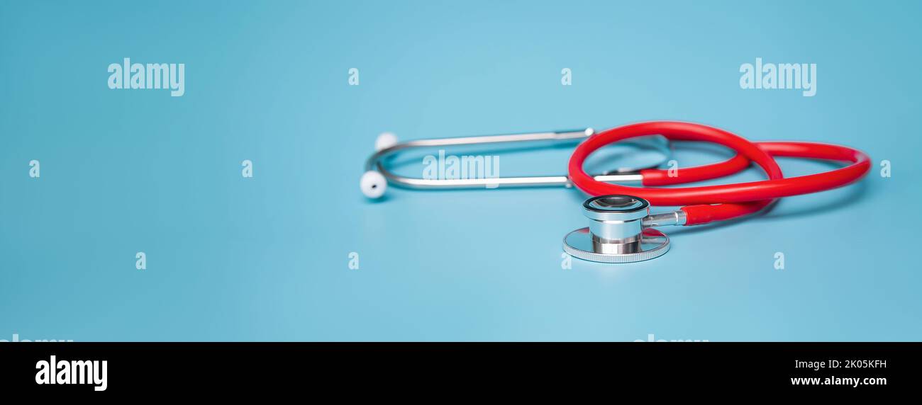 Doctor's red stethoscope on blue background, health insurance concept ...