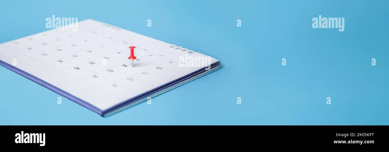 Red pin on event calendar. Planner calendar on blue background, plan ...