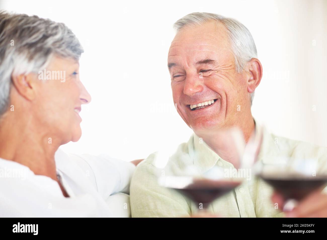 Couple toasting with red wine. Smiling mature man and woman toasting ...