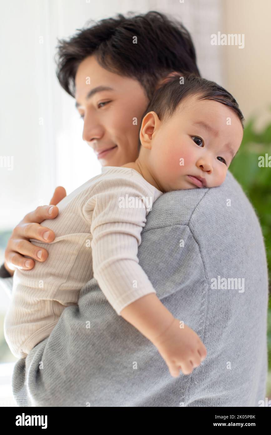 Young Chinese father holding his baby Stock Photo - Alamy