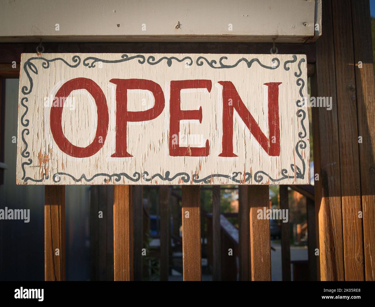 Hand painted sign advising OPEN in red lettering on board with rustic ...