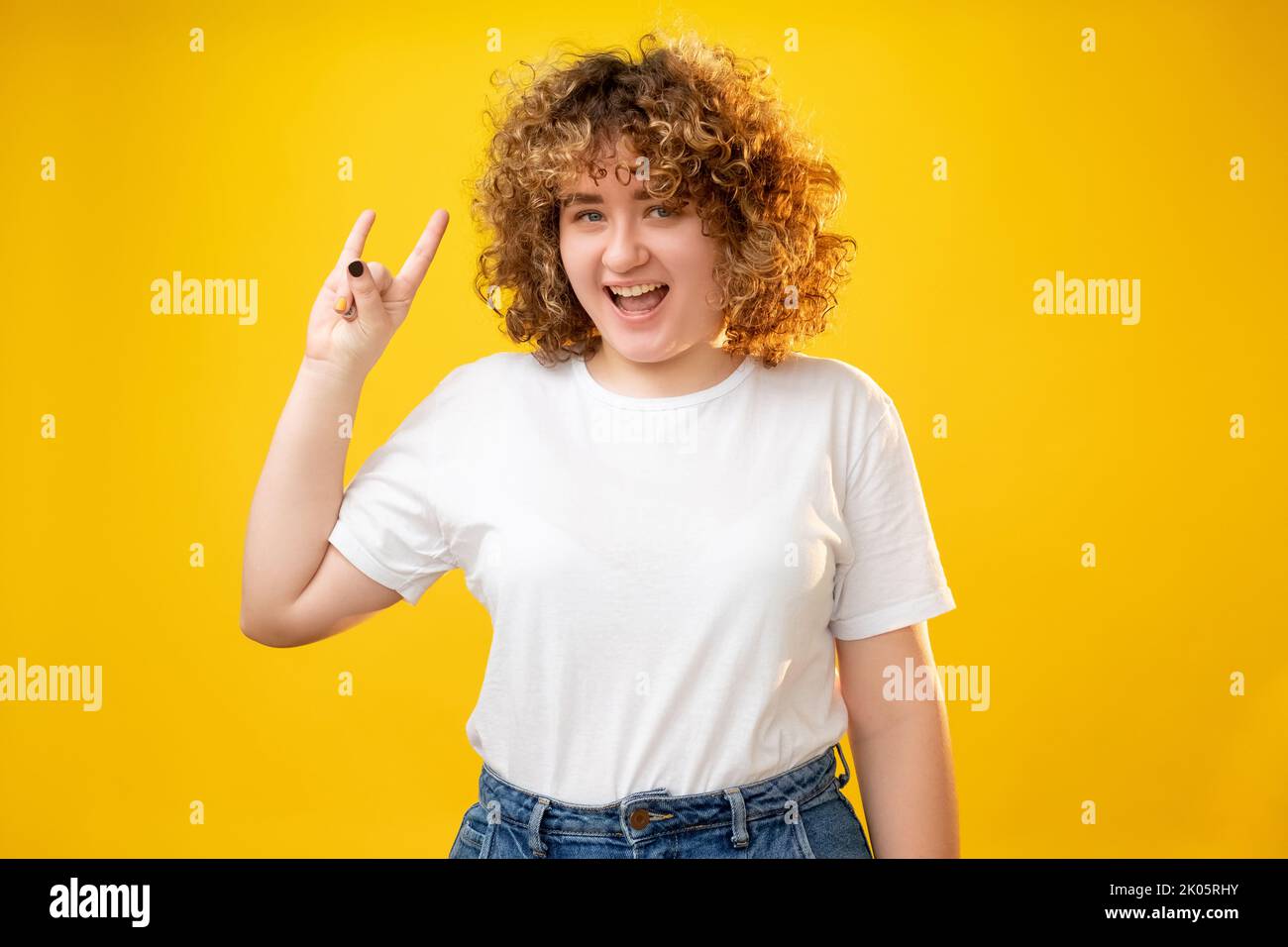 rock gesture body positive overweight happy woman Stock Photo - Alamy