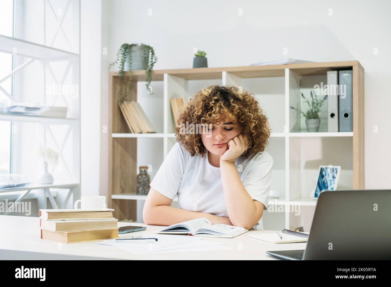 demotivated student exam study bored woman reading Stock Photo - Alamy