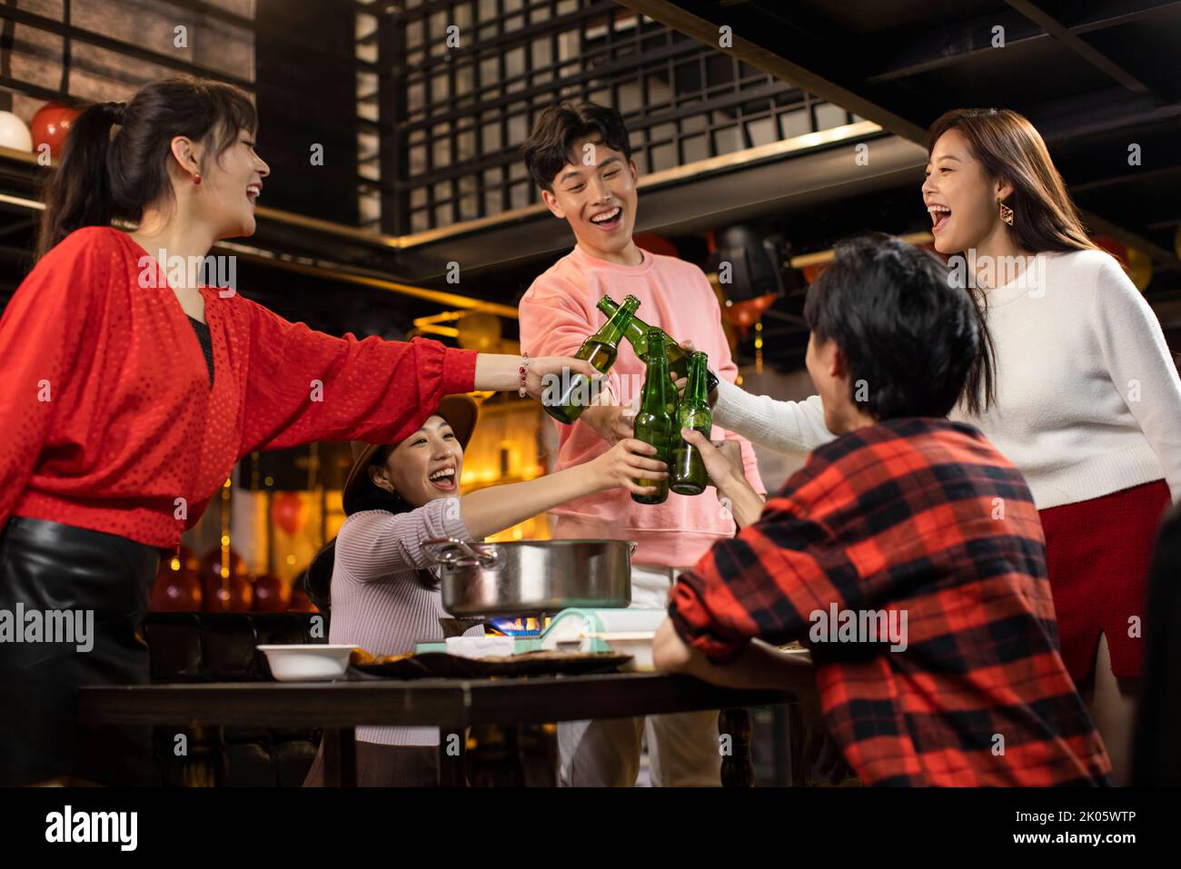 Young Chinese friends toasting for Chinese new year Stock Photo - Alamy