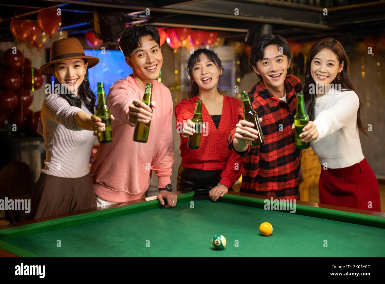 Young Chinese friends toasting for Chinese new year Stock Photo - Alamy