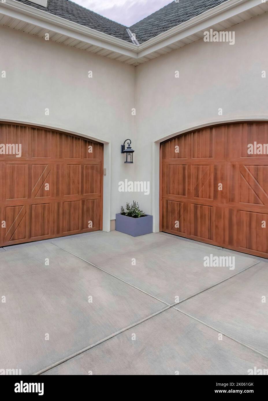 Vertical Puffy clouds at sunset Decorated three-car garage exterior ...