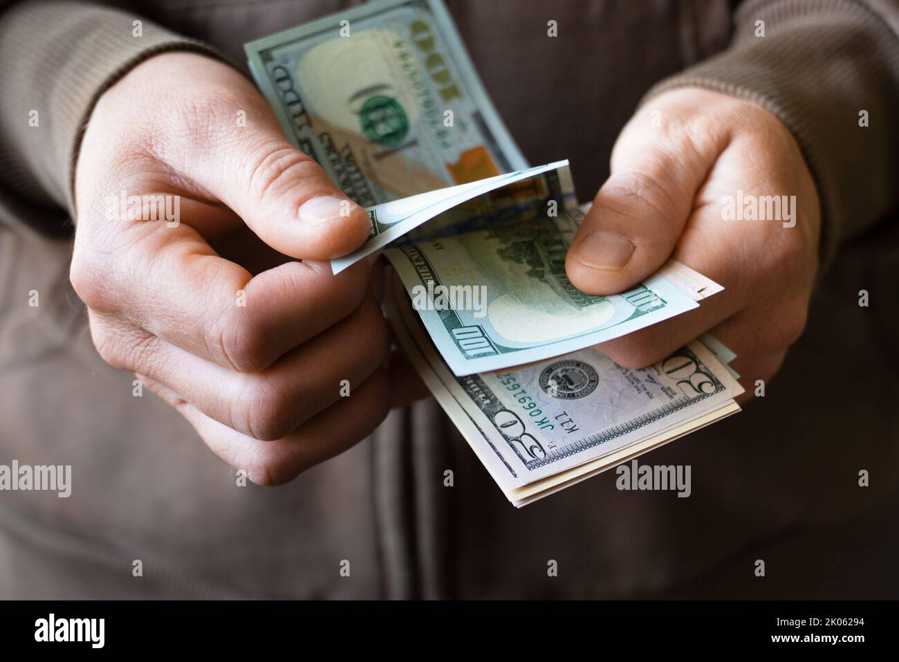 White male count US dollar bills bills in his hands Stock Photo - Alamy