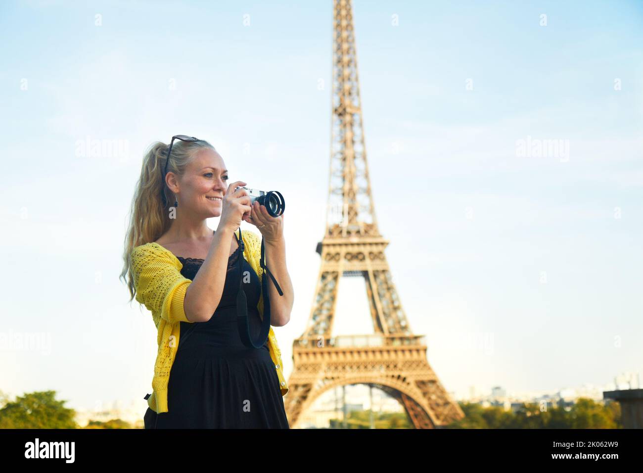 Taking photos of her trip. An attractive young woman taking photos ...