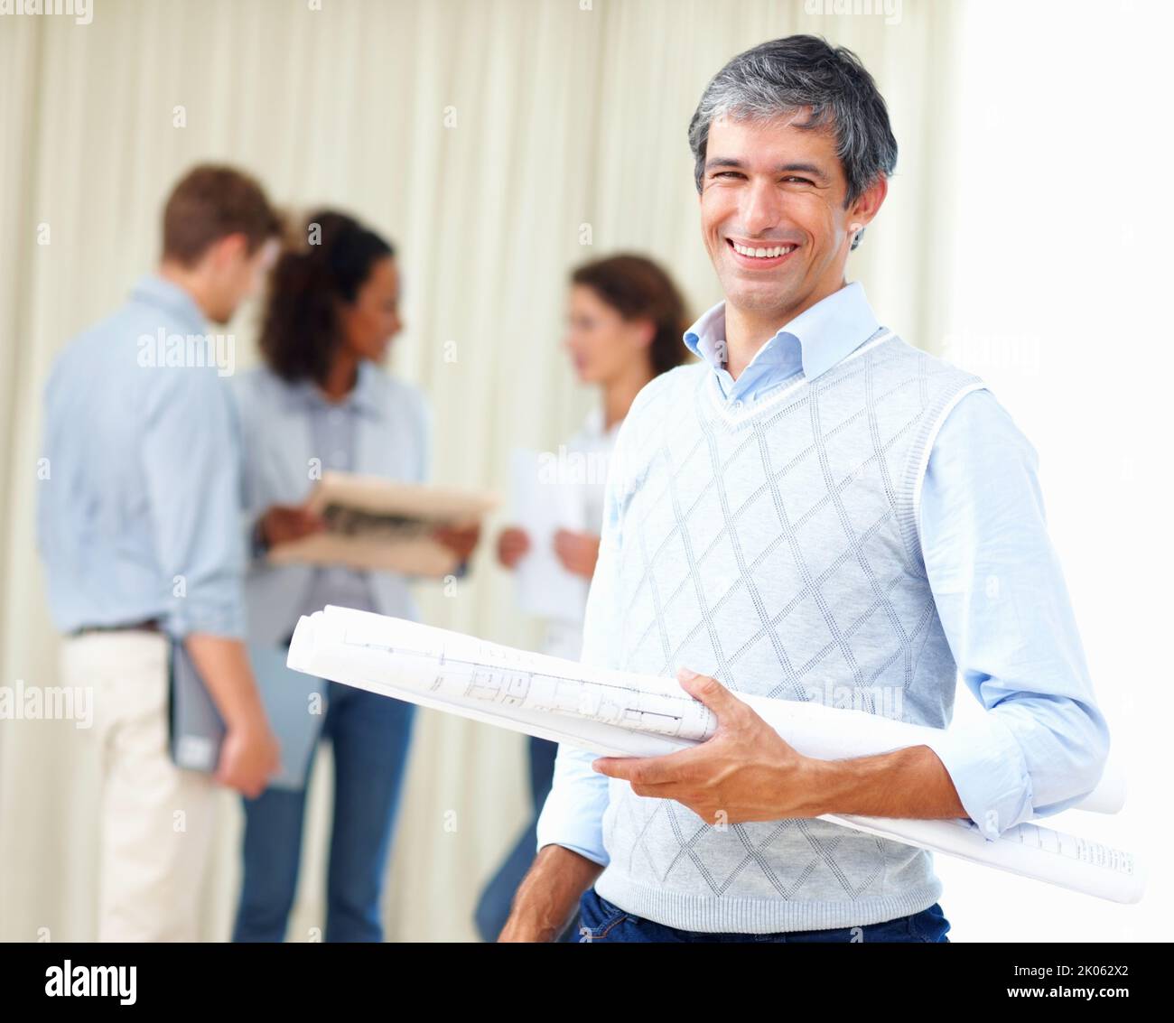 Smiling business man holding blueprint. Portrait of mature business man ...