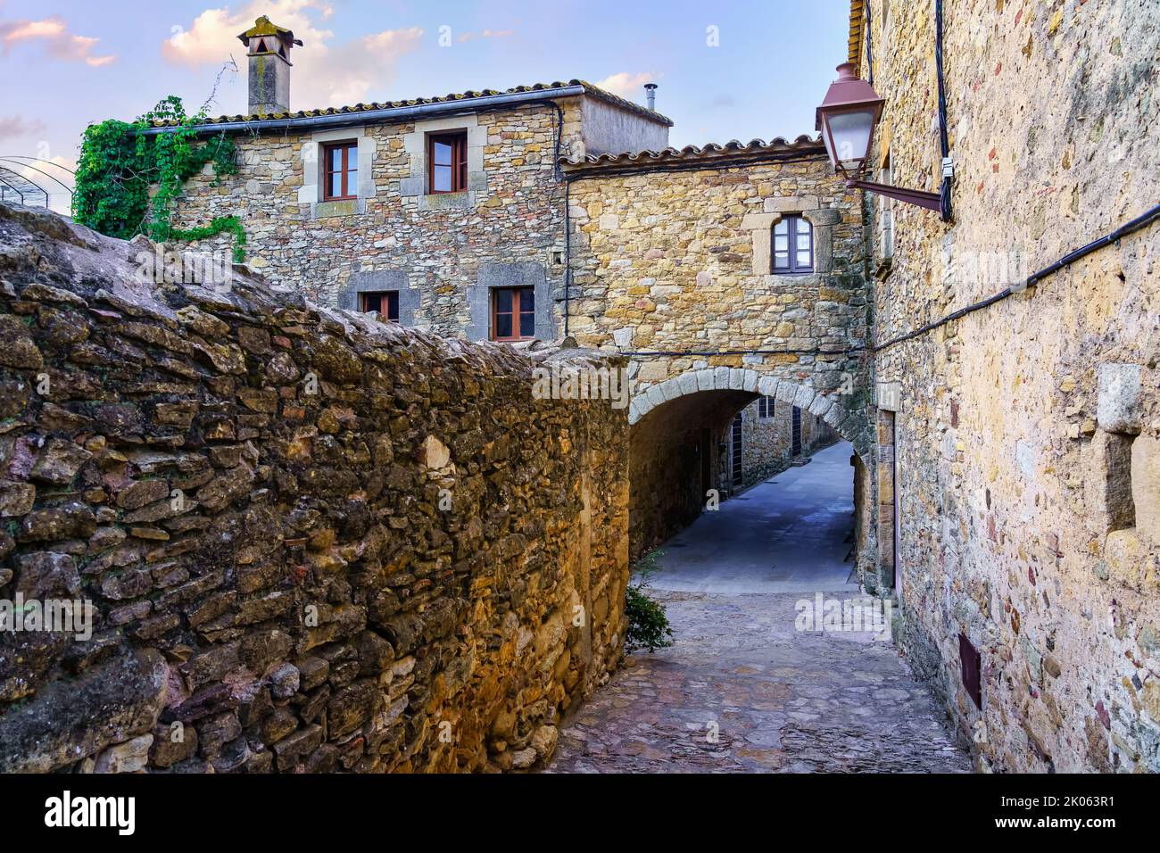 Nice alley with medieval houses and arched passageways under the ...