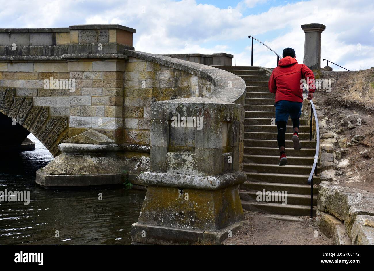 PERSON RUNNING UP STAIRS OF BRIDGE Stock Photo - Alamy