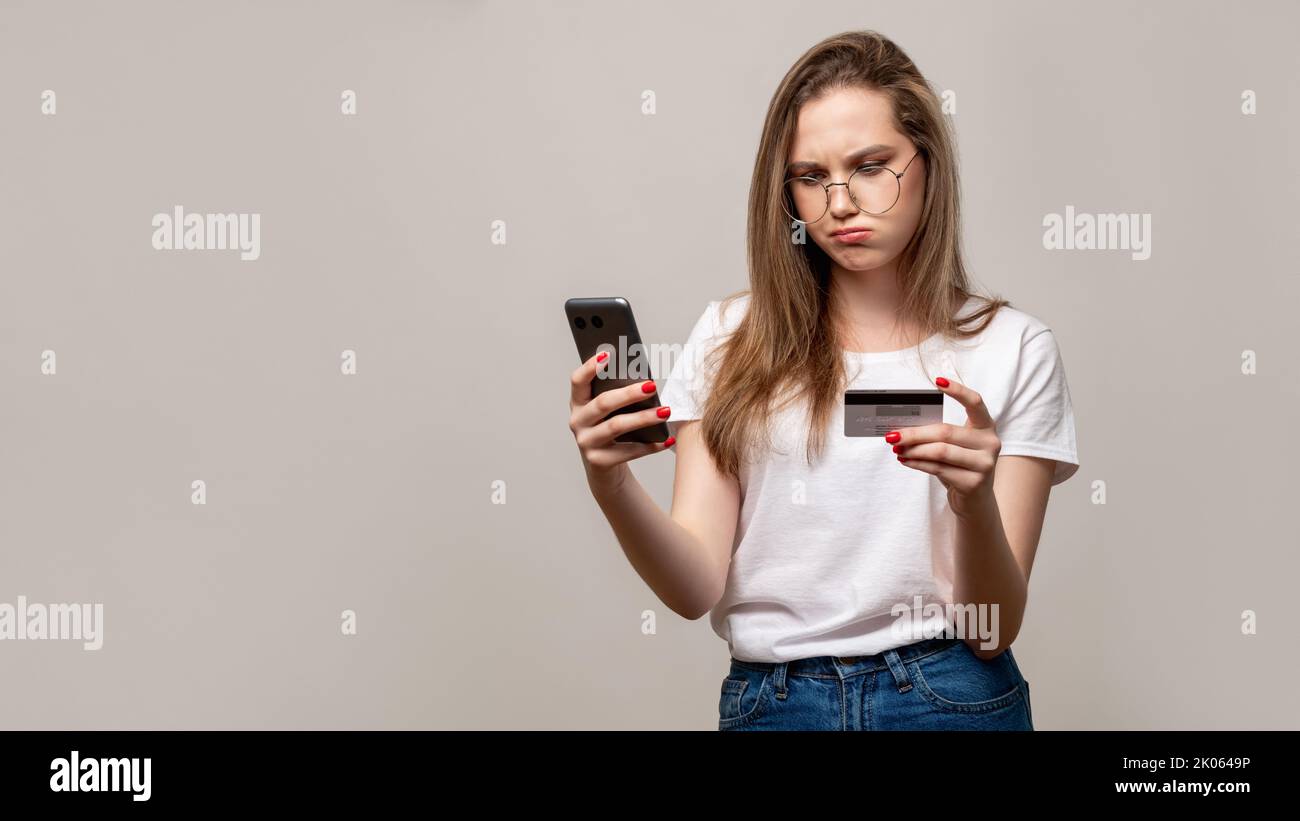 bank fraud mobile scam confused woman credit card Stock Photo - Alamy