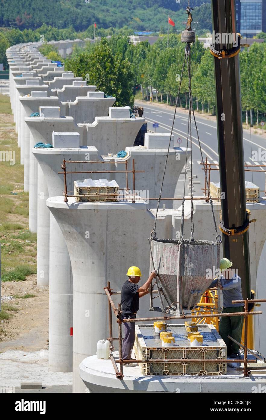 YANTAI, CHINA - SEPTEMBER 10, 2022 - Construction workers pour stones ...
