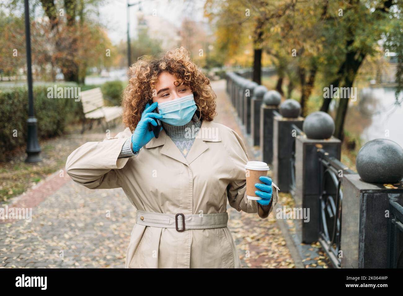 distance communication phone call woman mask park Stock Photo - Alamy