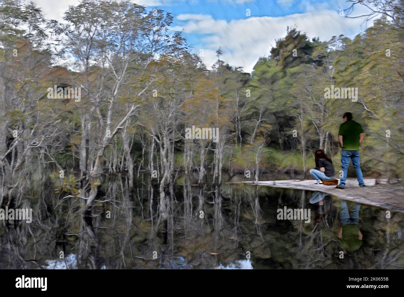 Two people meet by a pool in the bush hi-res stock photography and ...