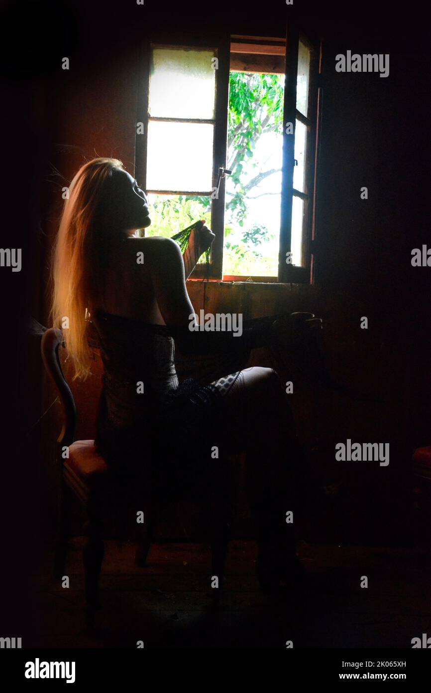 LADY BY WINDOW LIGHT Stock Photo - Alamy