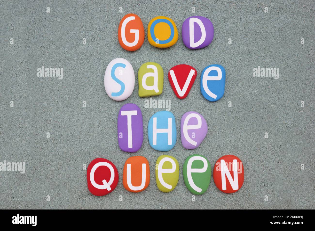 God save the Queen, creative slogan composed with multi colored stone ...