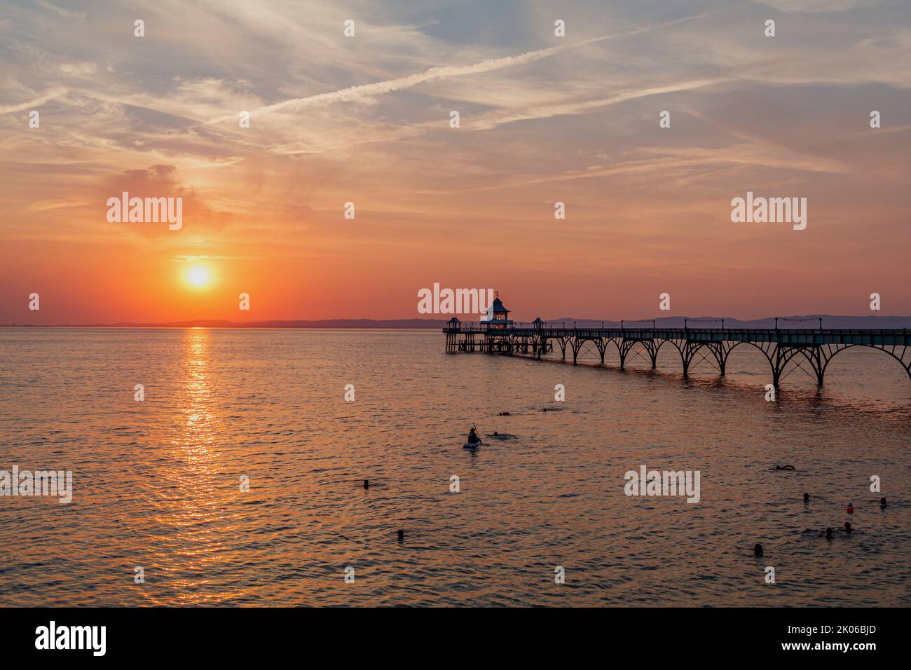 The setting sun lighting up the cloud cover on the horizon Stock Photo ...