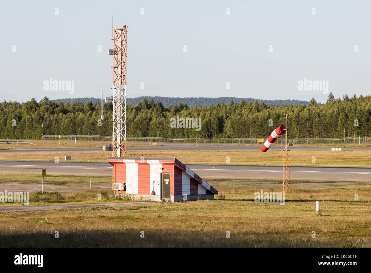 Airport infrastructure with antennas, runway, wind flag and taxiways ...