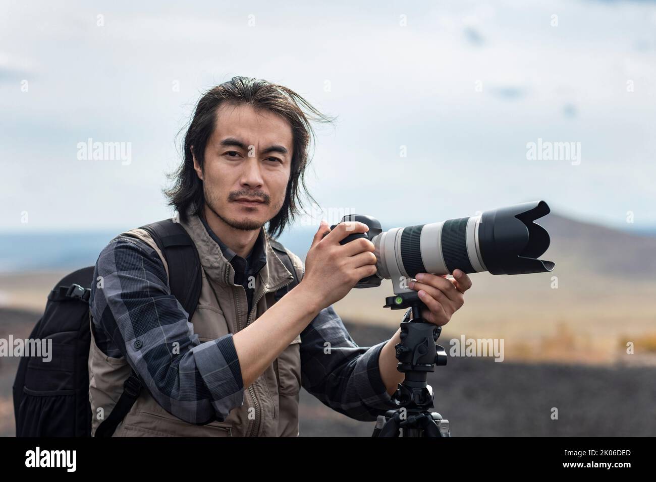 Chinese male photographer taking photos outdoors Stock Photo - Alamy