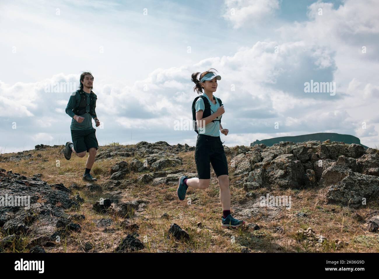 Happy Chinese couple trail running in nature Stock Photo - Alamy