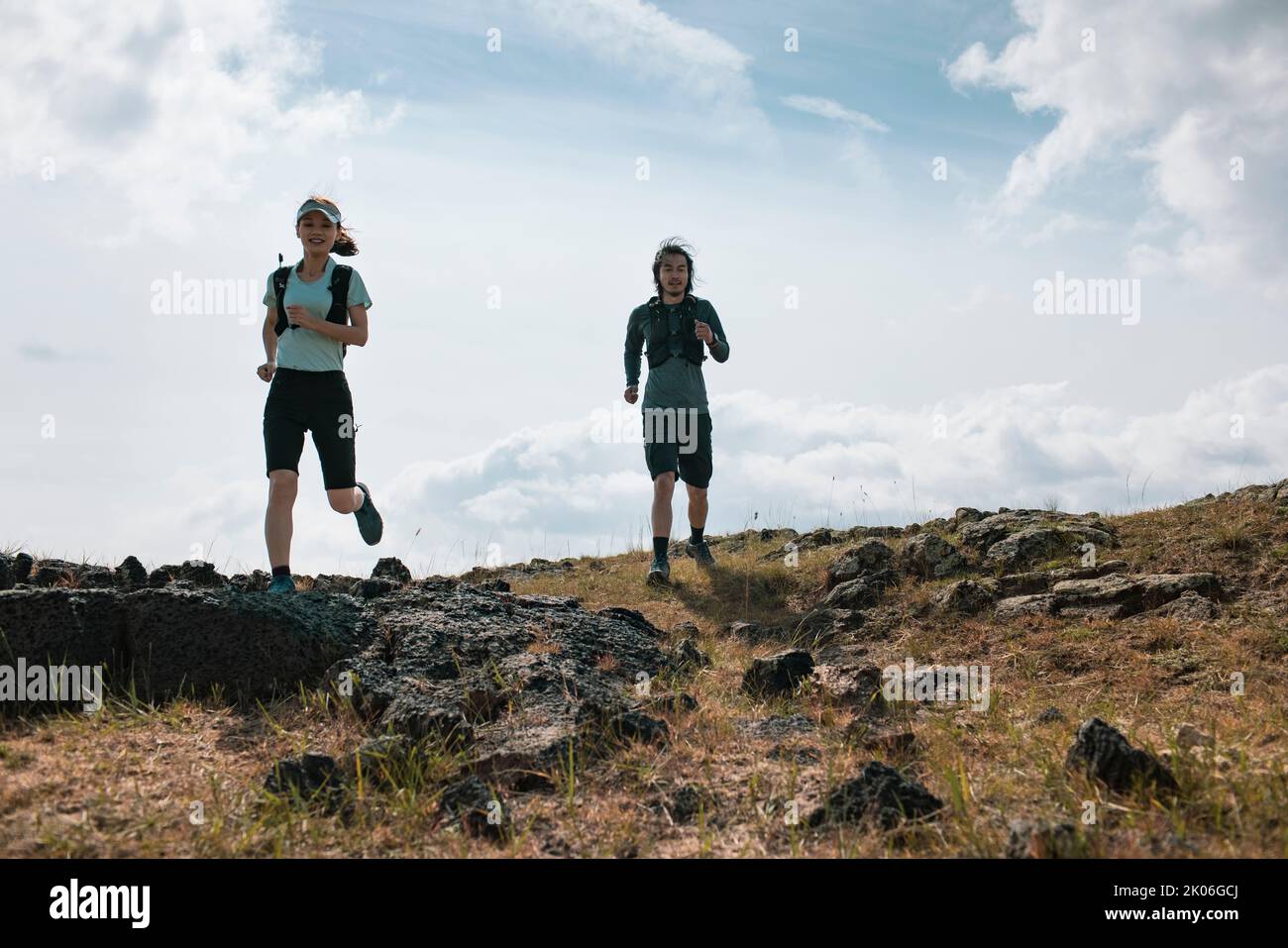 Happy Chinese couple trail running in nature Stock Photo - Alamy
