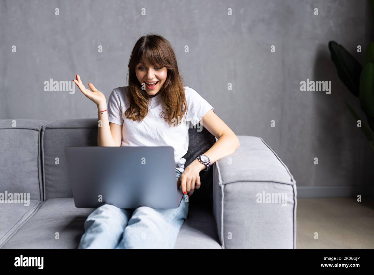 Excited laptop user woman staring at display, shouting for joy, gasping ...