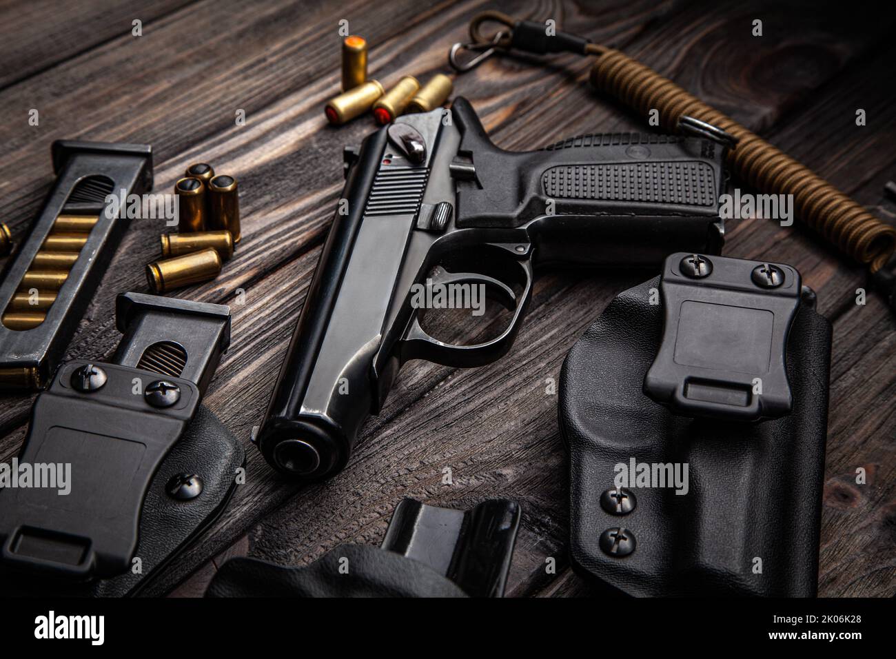 A modern black pistol and ammunition on dark metal background. Weapons ...