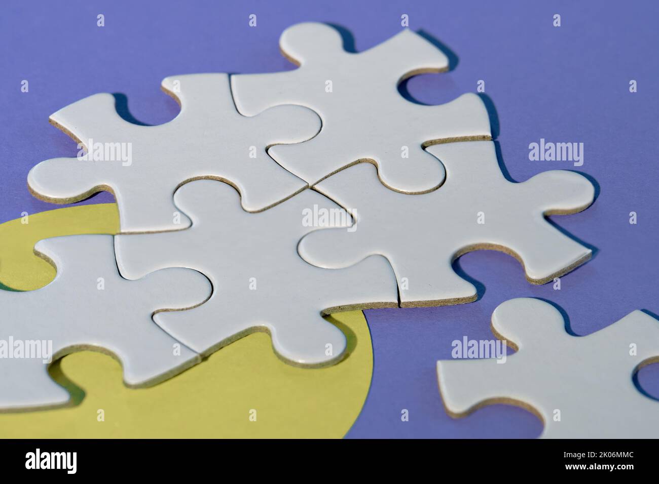 Close-up on jigsaw puzzle pieces, blank white paper jigsaw puzzle ...