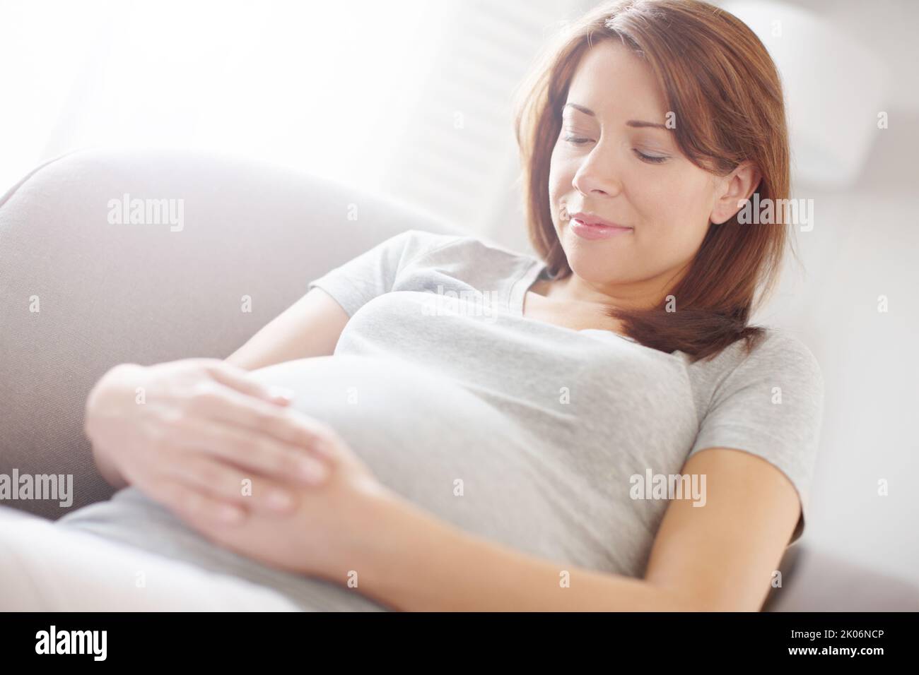 Youre already my little angel...A pretty, pregnant woman looking ...