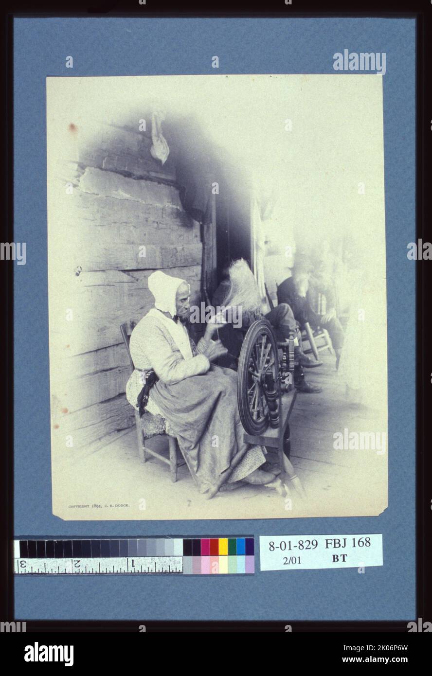 Elderly woman sitting on porch spinning, c1894 Stock Photo - Alamy