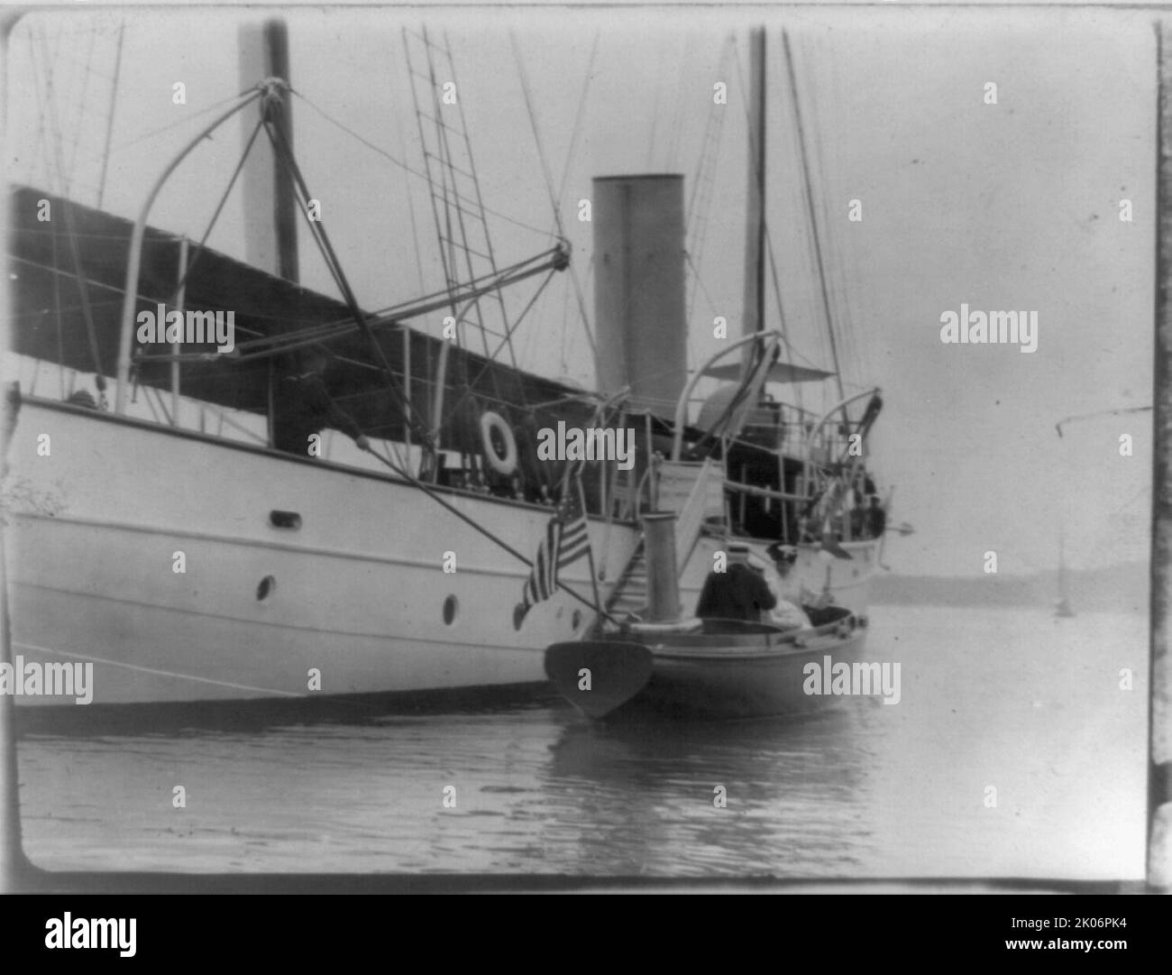 Man and woman in small boat alongside large boat or ship, Oyster Bay ...