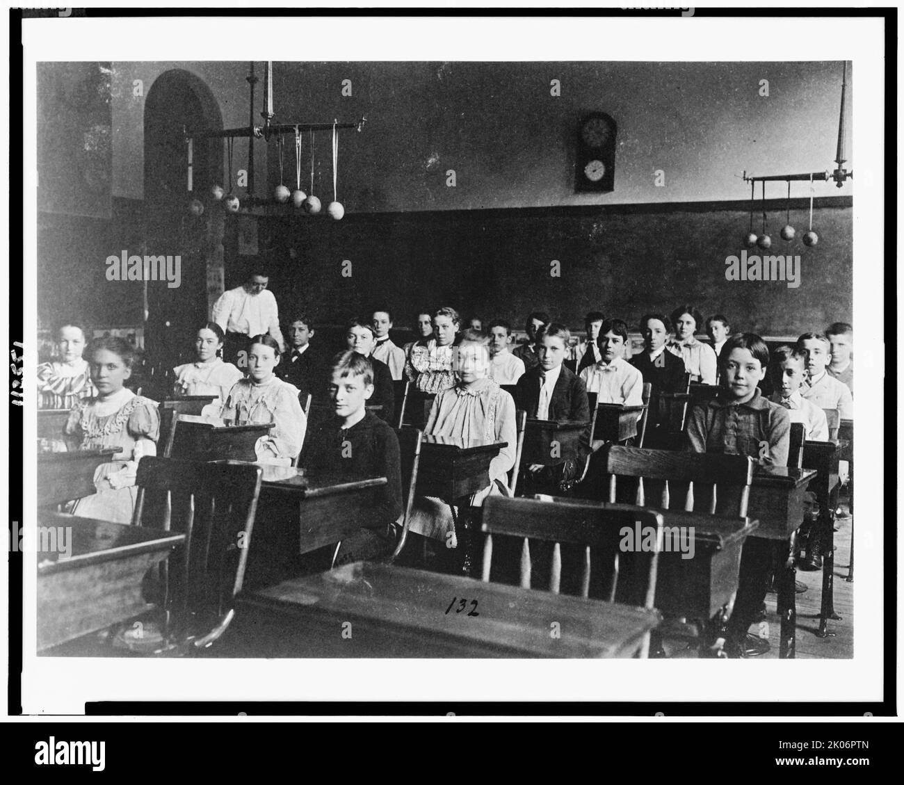 Boys girls seated in Black and White Stock Photos & Images - Alamy