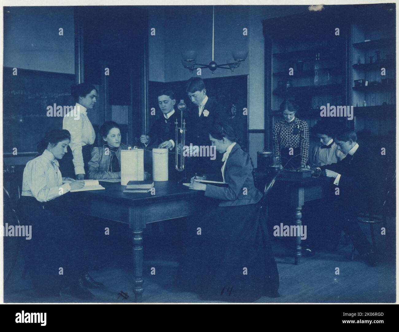 Students conducting electrical experiments with batteries, Western High ...