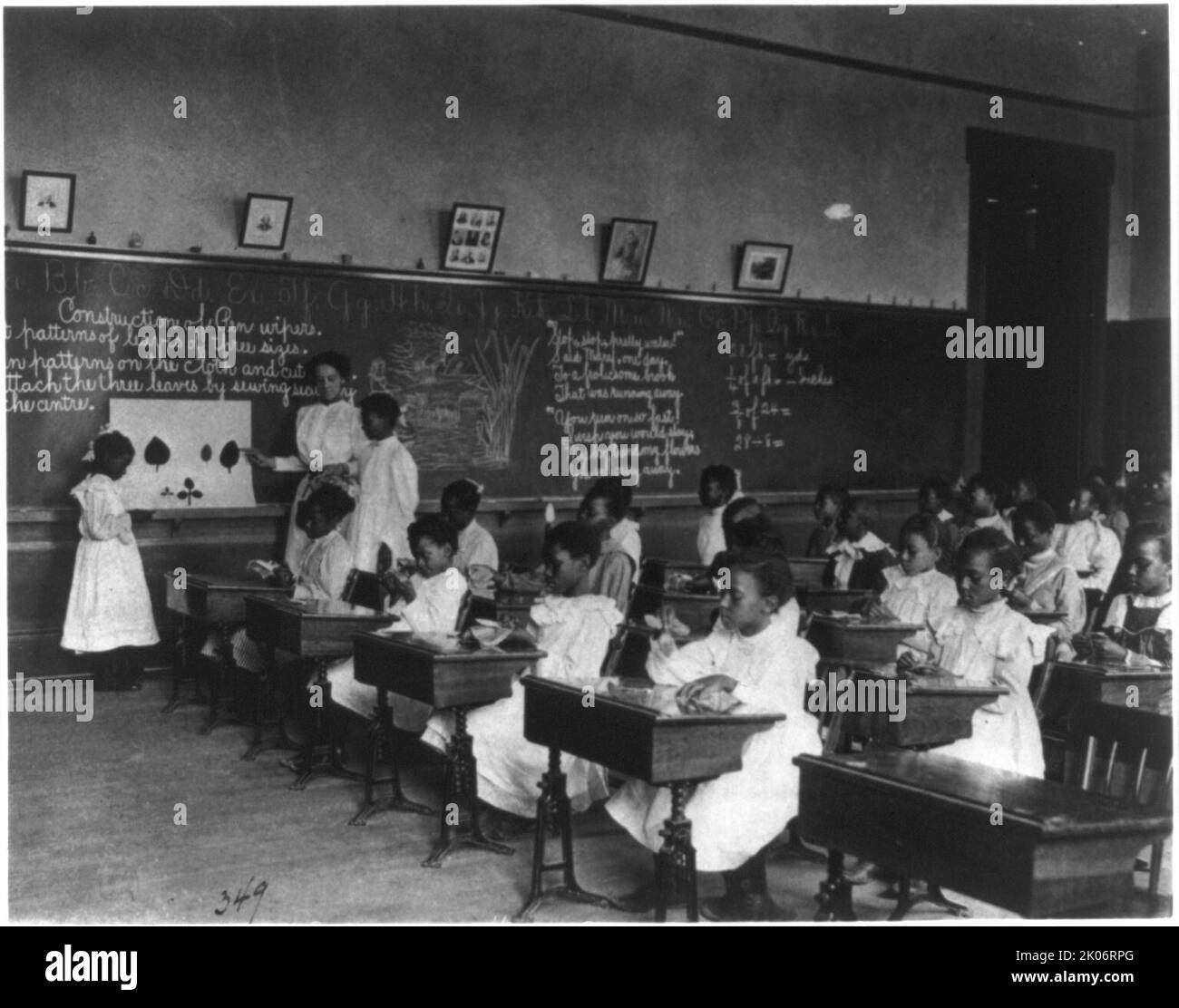 African American schoolgirls in classroom, learning to sew, (1899 Stock ...