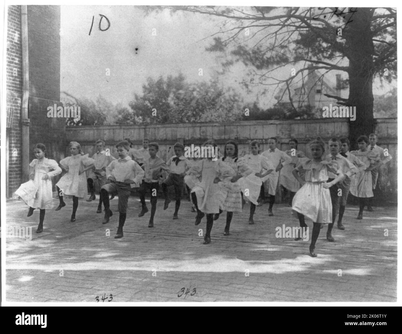 School children learning a dance in a school yard, Washington, D.C ...